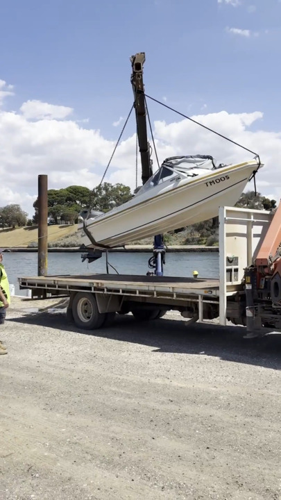 Boat hauled from Corio Bay after sinking | Herald Sun